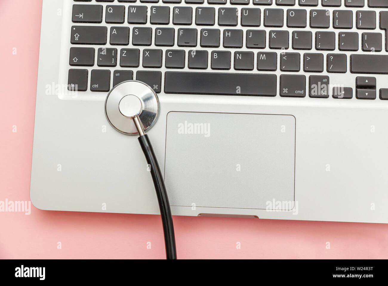 Stethoscope keyboard laptop computer isolated on pink background ...