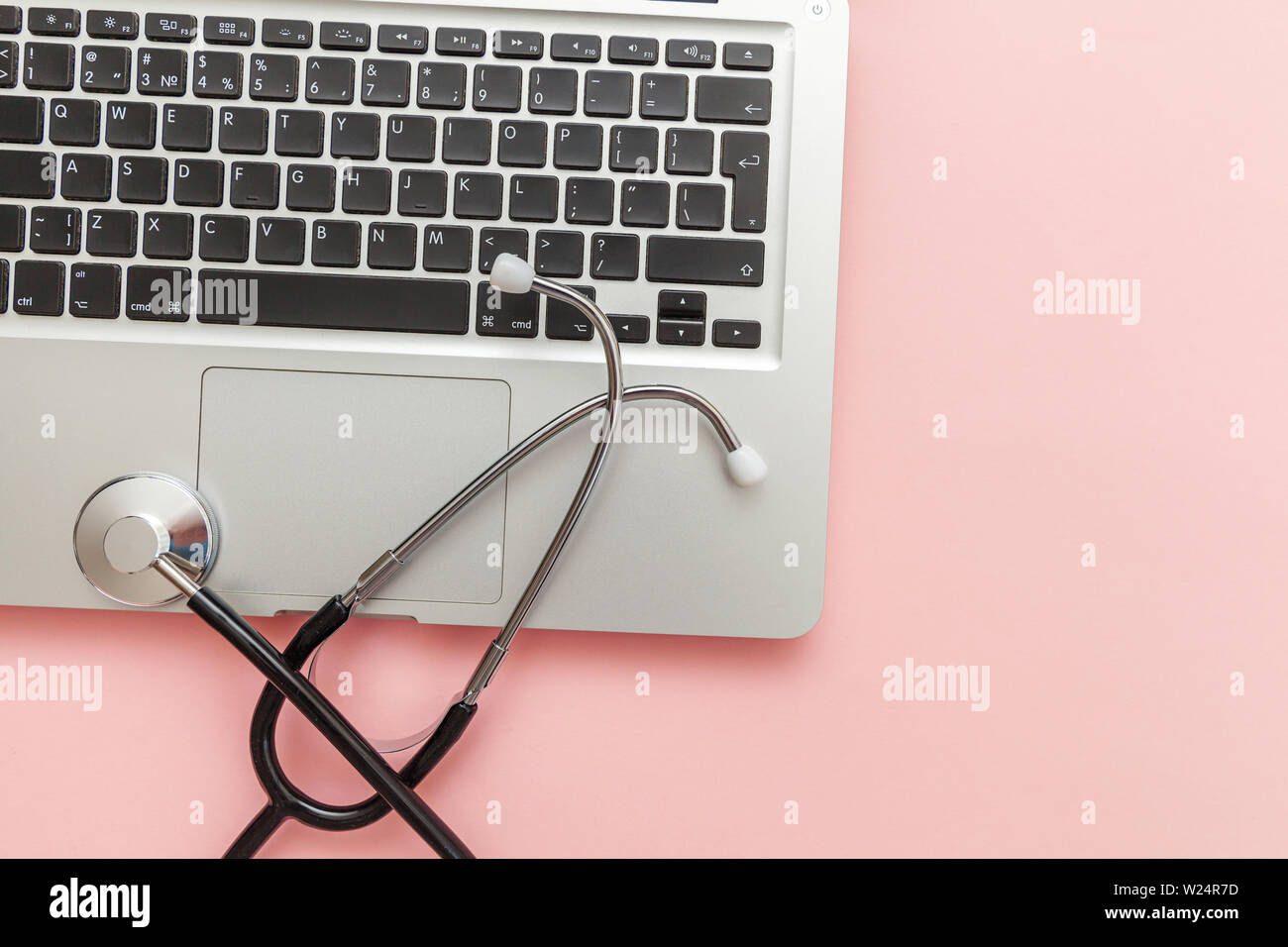 Stethoscope keyboard laptop computer isolated on pink background ...