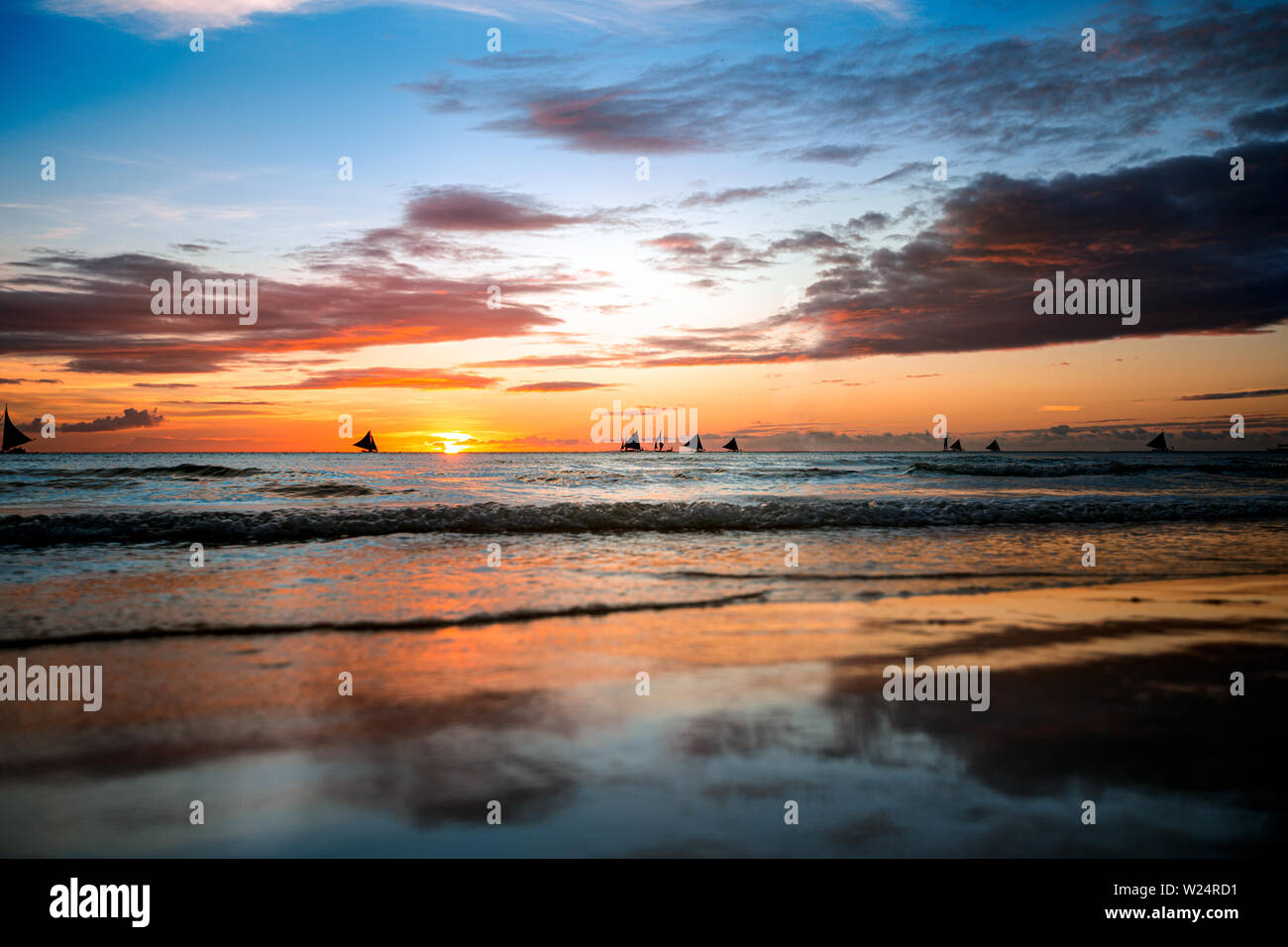 Beautiful sunset sea with reflection of sky Stock Photo - Alamy