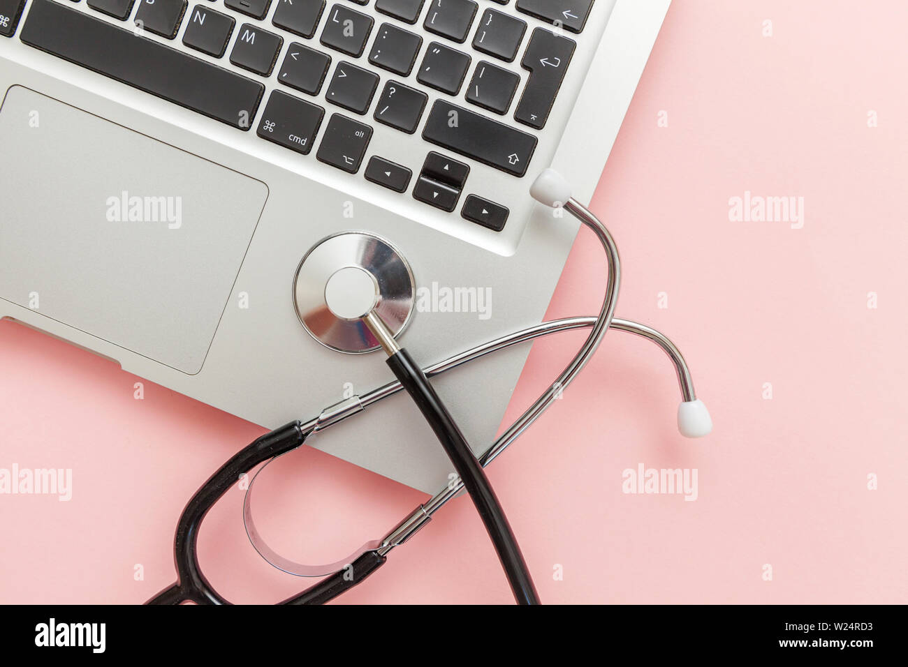 Stethoscope keyboard laptop computer isolated on pink background ...