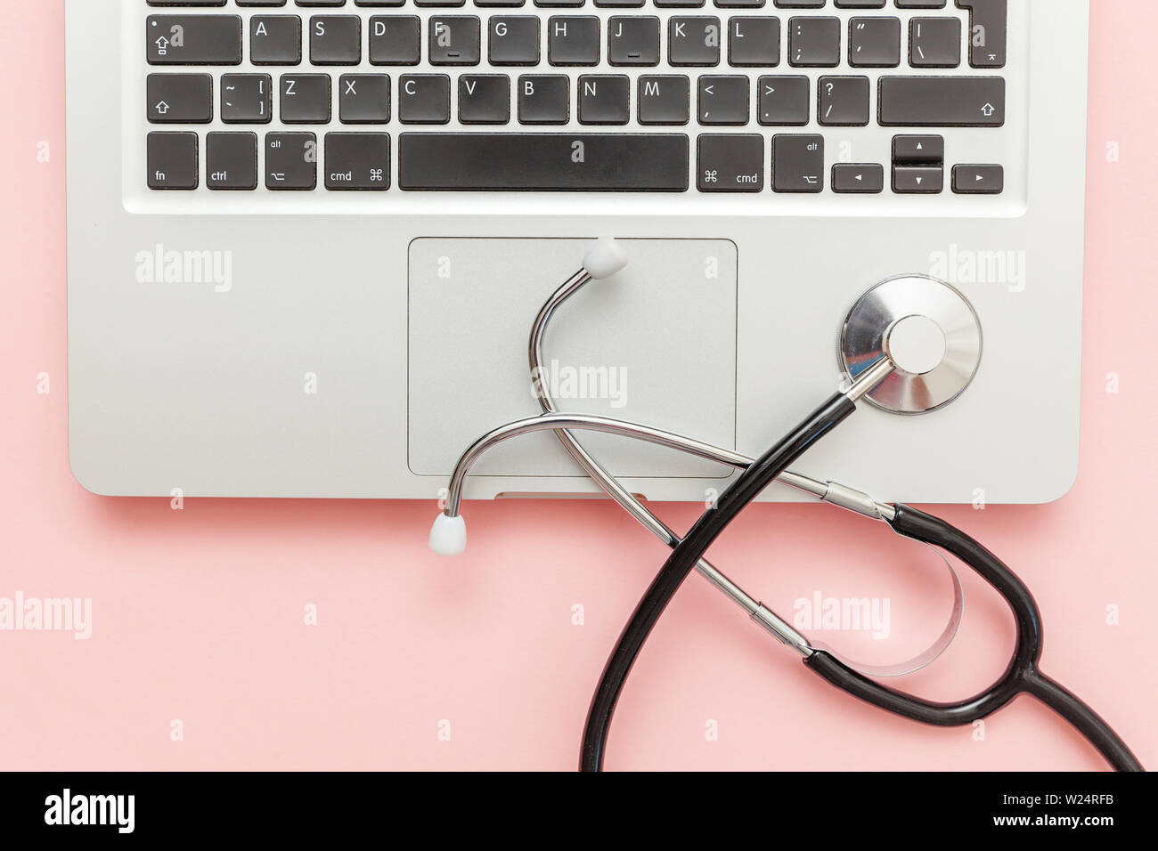 Stethoscope keyboard laptop computer isolated on pink background ...