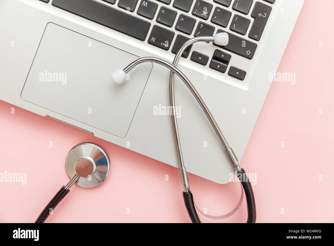 Stethoscope keyboard laptop computer isolated on pink background ...
