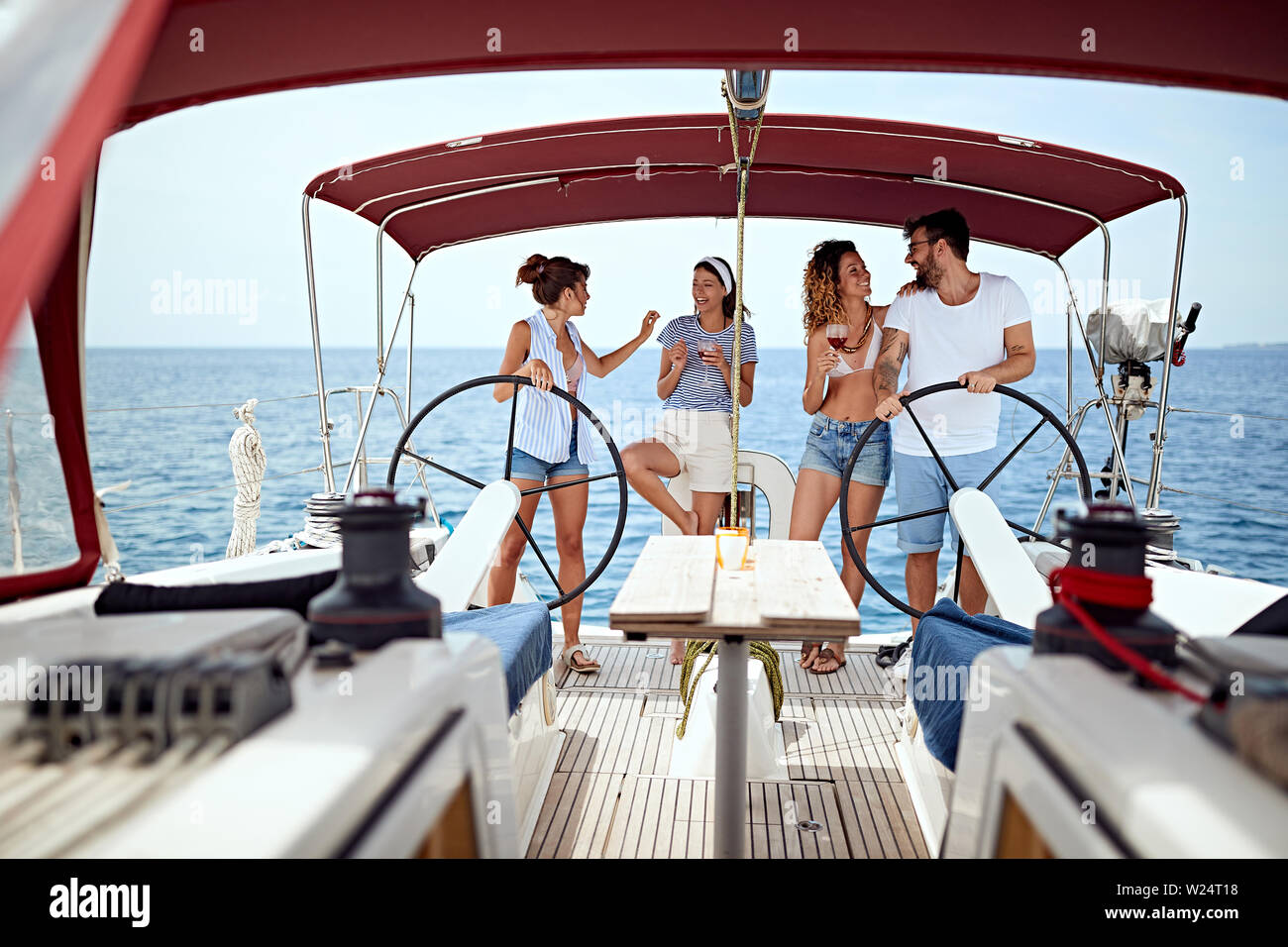 Happy young people sailing in a sea on the yacht Stock Photo - Alamy