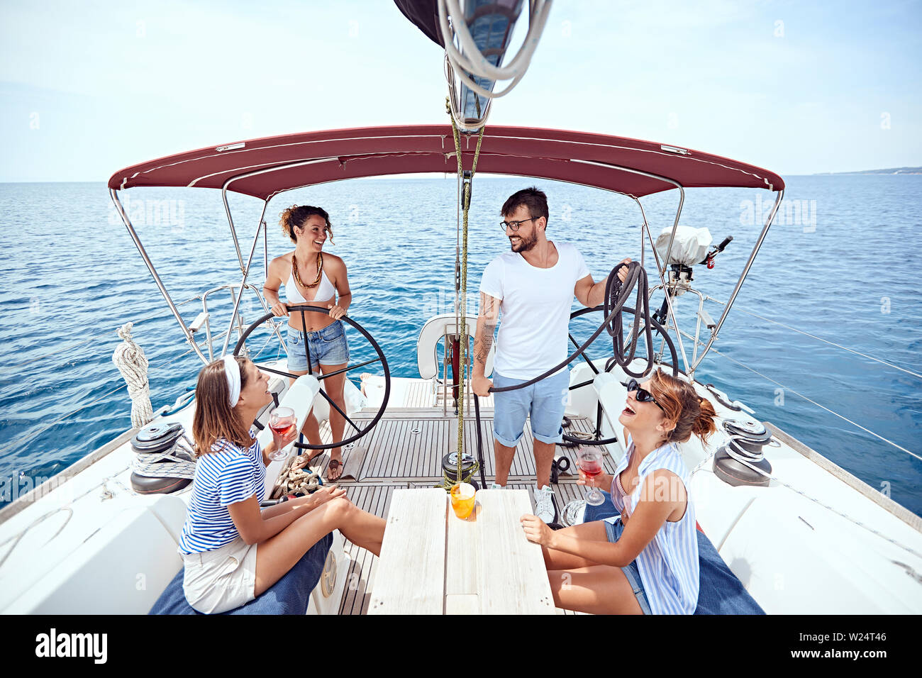 Happy people resting on a yacht drinking wine at summer vacation Stock ...