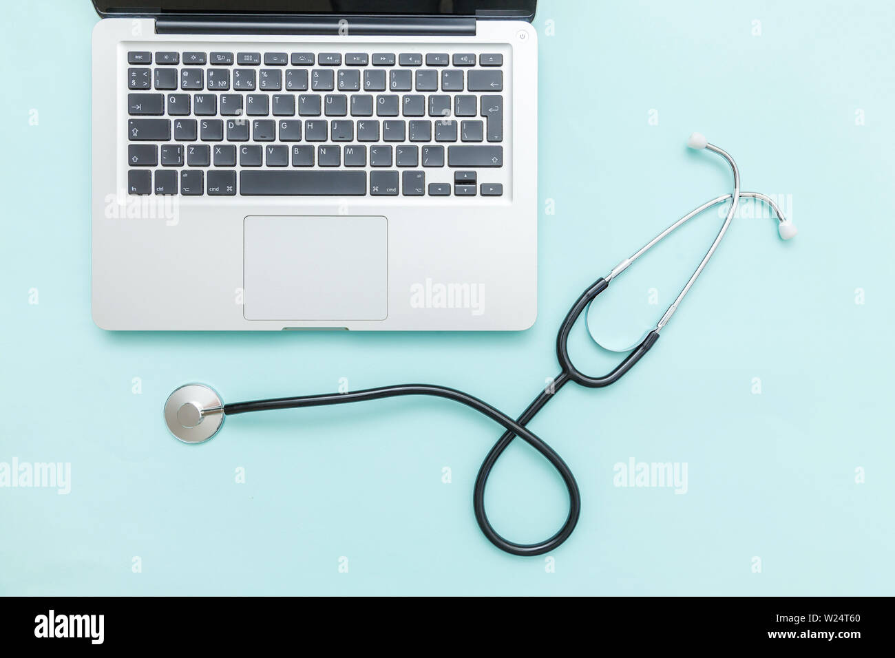 Stethoscope keyboard laptop computer isolated on blue background ...