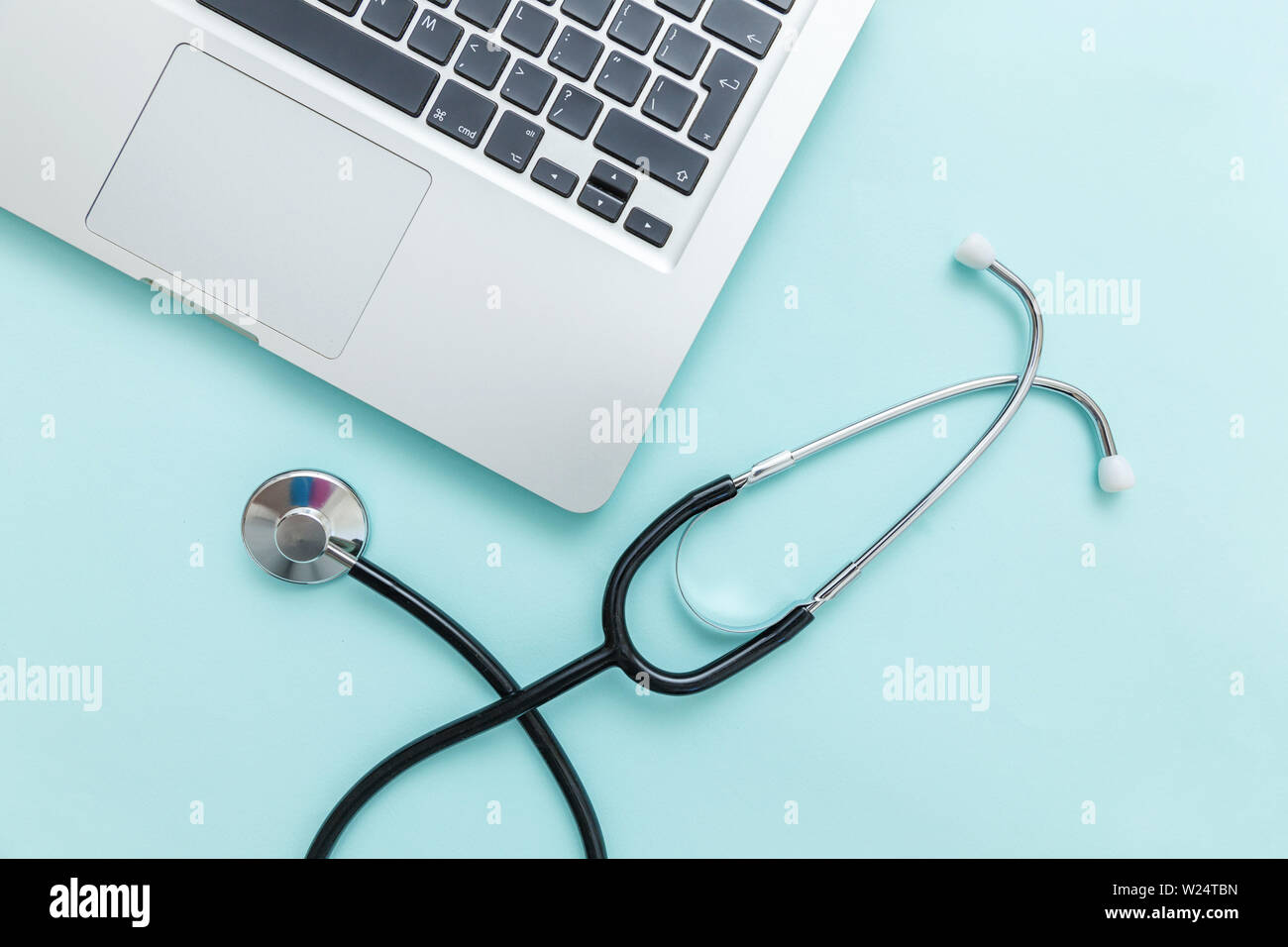 Stethoscope keyboard laptop computer isolated on blue background ...