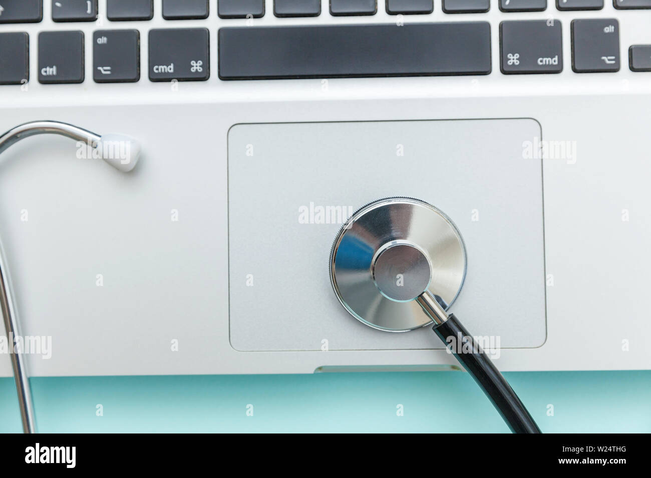 Stethoscope keyboard laptop computer isolated on blue background ...