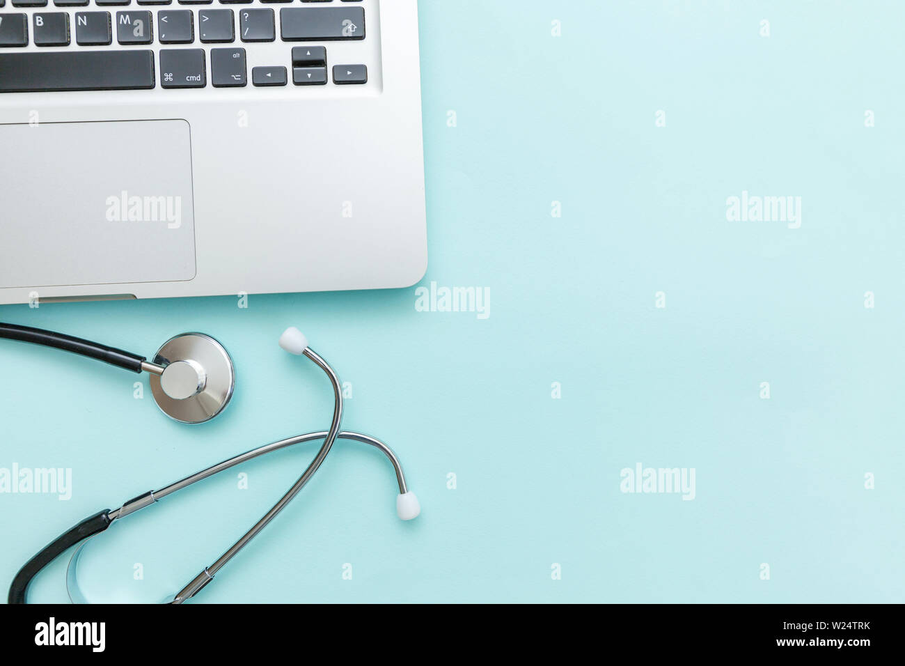 Stethoscope keyboard laptop computer isolated on blue background ...