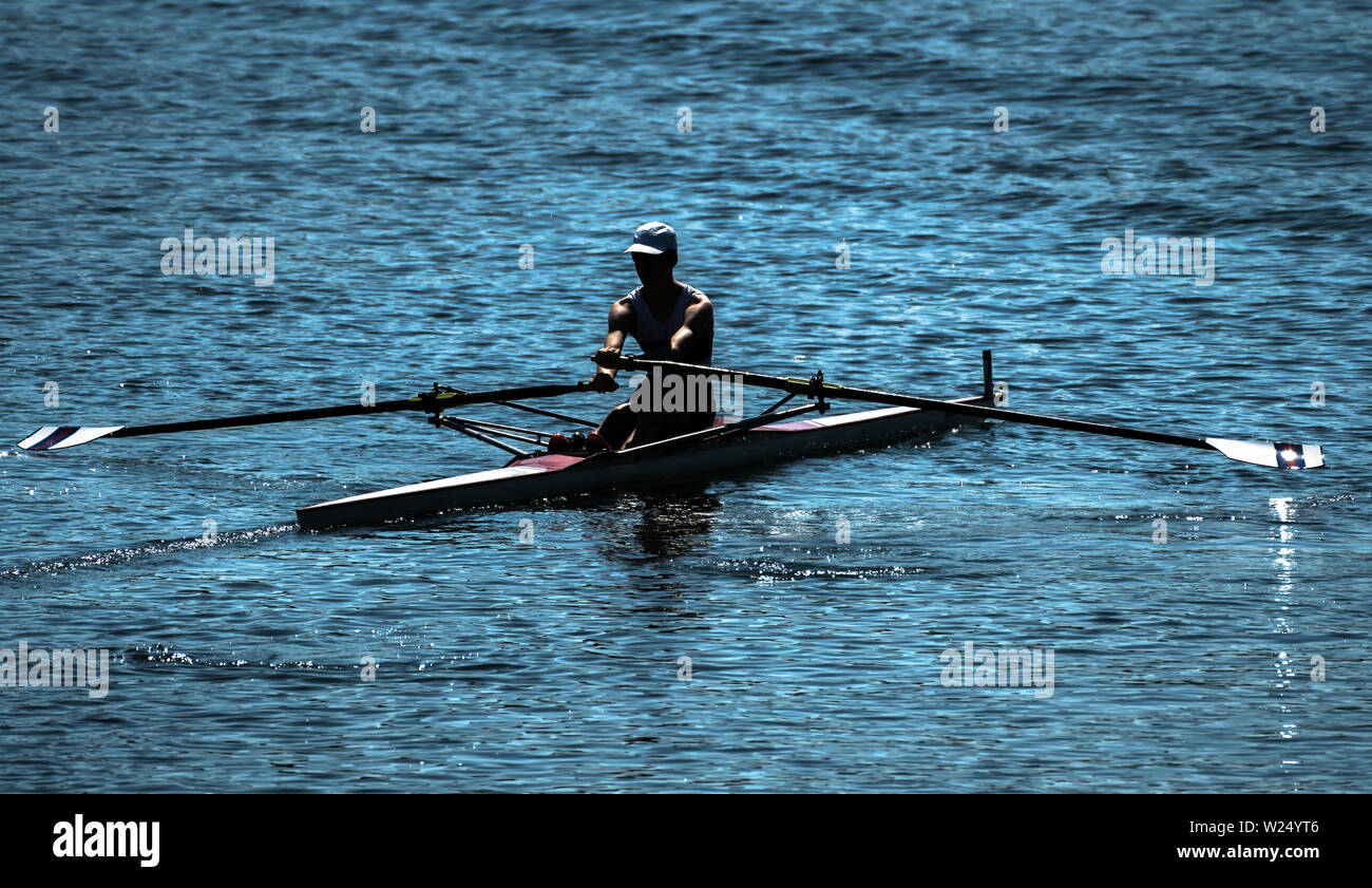 Single Rower In Racing Boat During Oar Stroke On Lake Stock Photo - Alamy