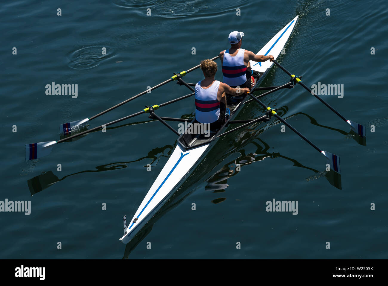 Two Male Rowers In A Double Racing Boat With Synchronous Oar Stroke ...