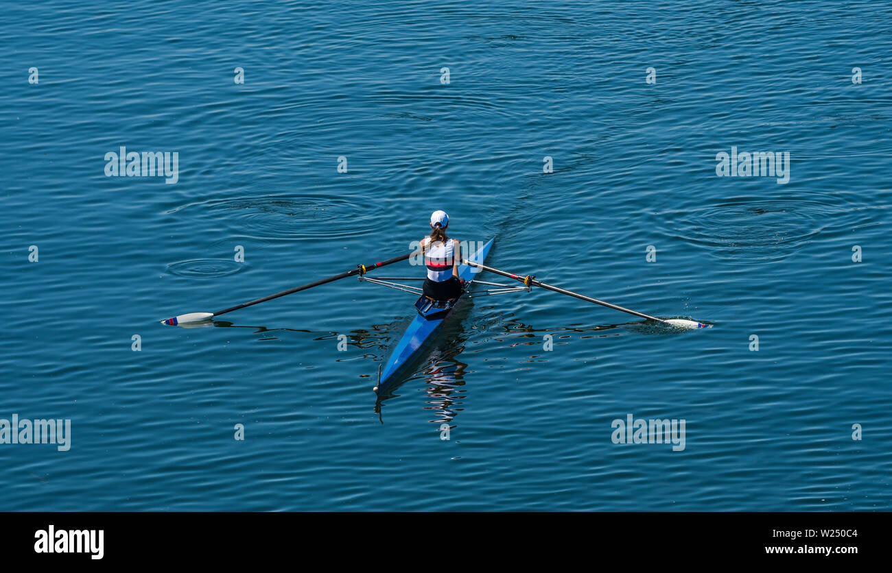 Single Female Rower In Racing Boat Stock Photo - Alamy