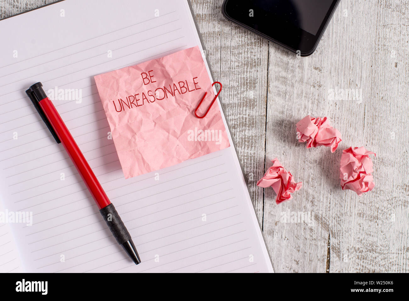 Writing note showing Be Unreasonable. Business concept for Behaving not ...