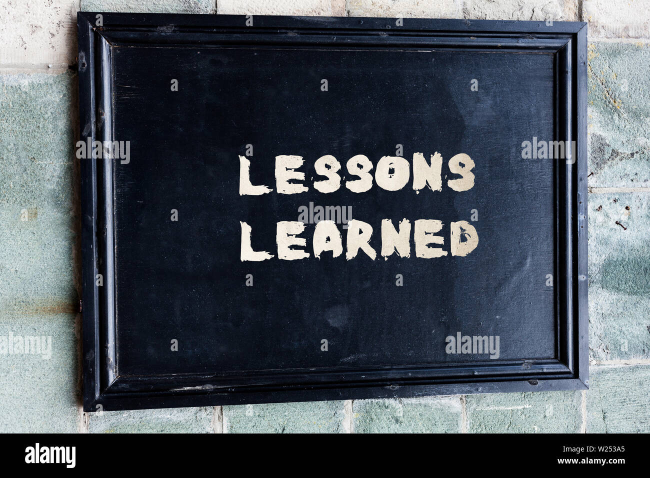 Writing note showing Lessons Learned. Business concept for the ...