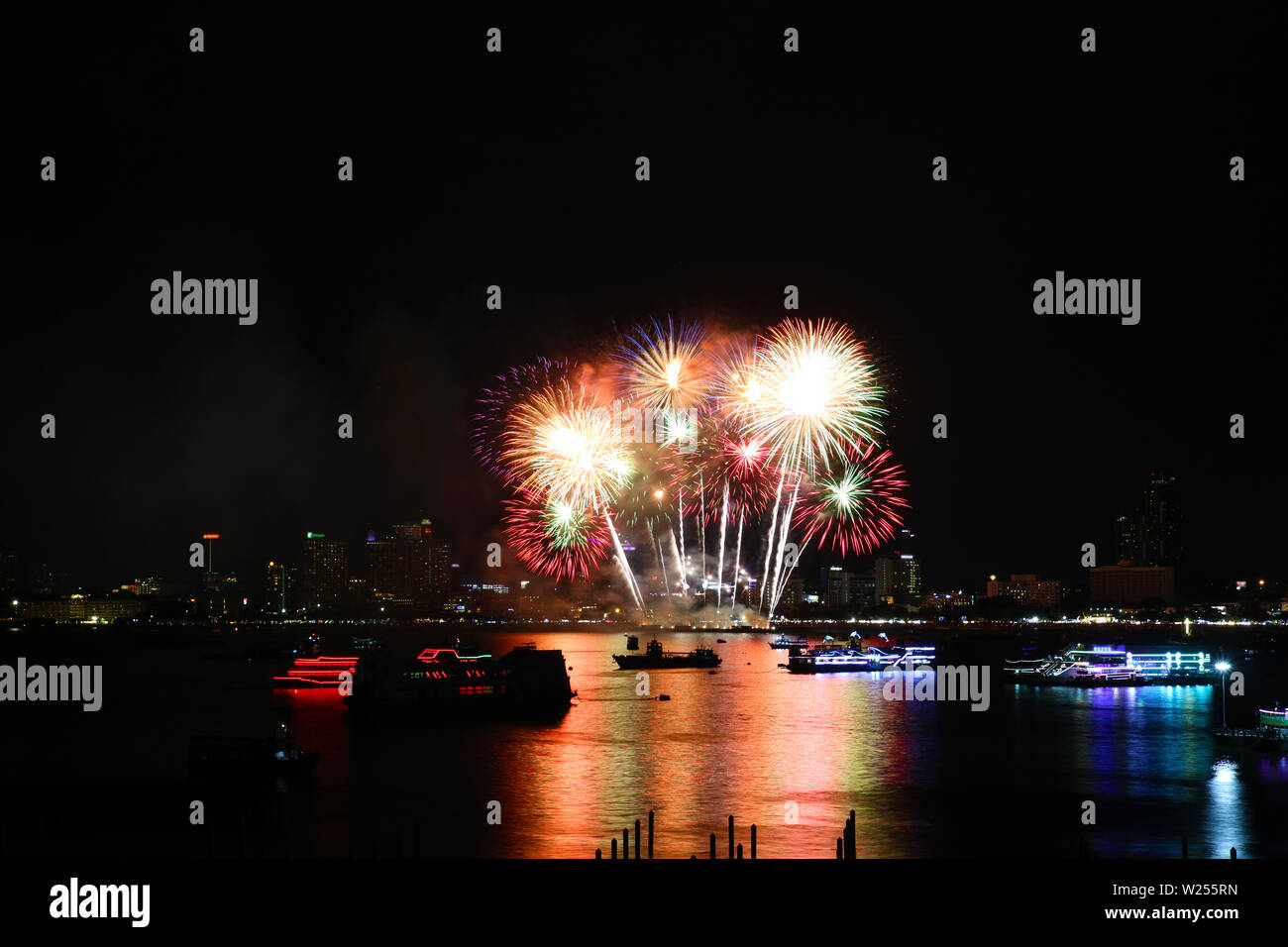 Pattaya city thailand fireworks on beach and reflection color on water ...