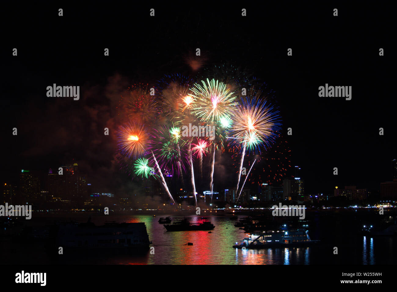 Pattaya city thailand fireworks on beach and reflection color on water ...