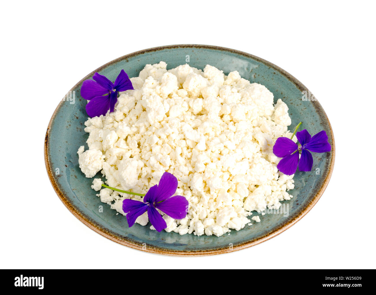 Blue plate with granulated cottage cheese Stock Photo - Alamy
