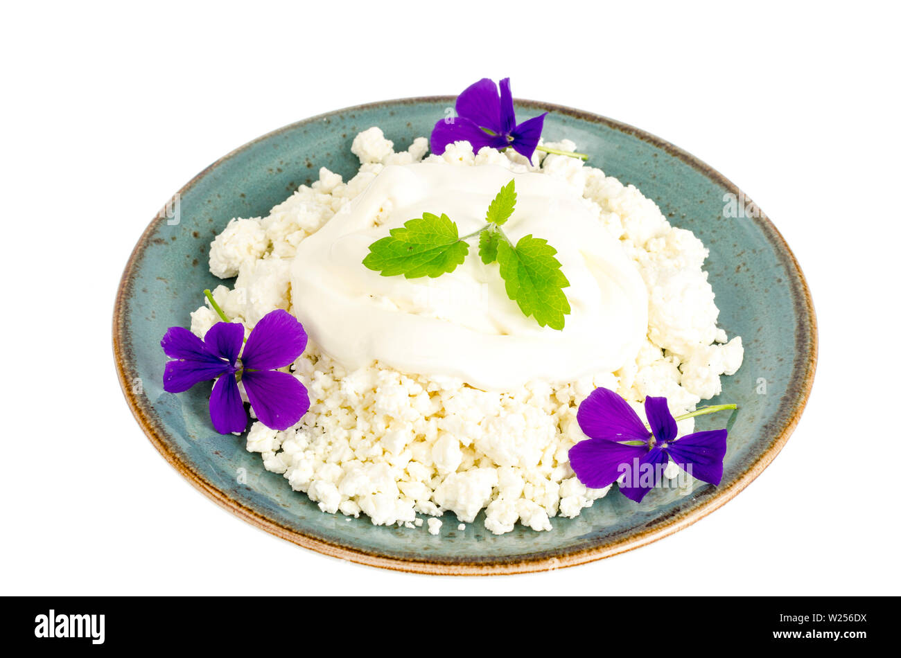 Blue plate with granulated cottage cheese Stock Photo - Alamy