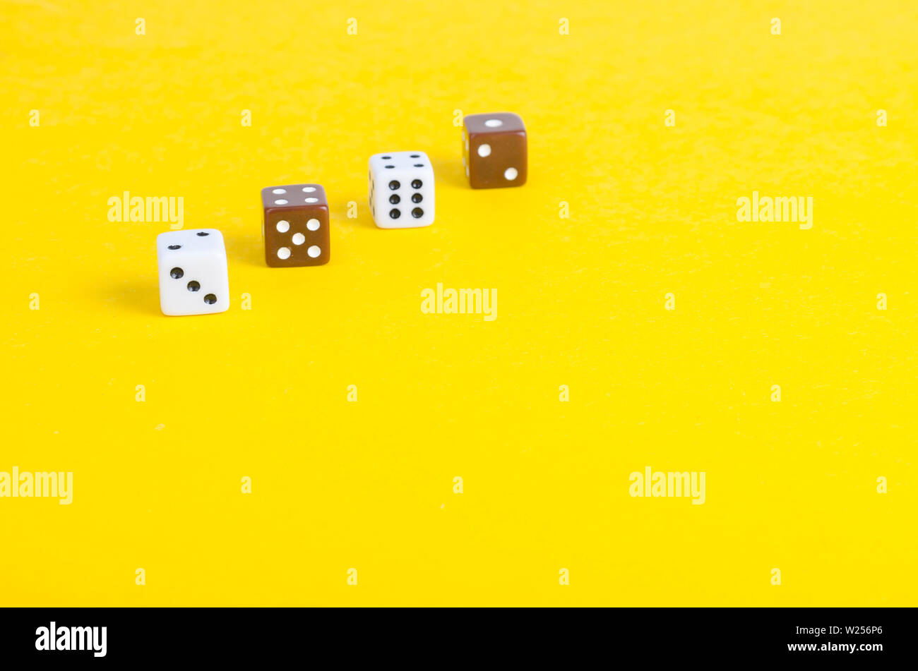 Simple game cubes, dice on bright yellow background. Casino gambling ...