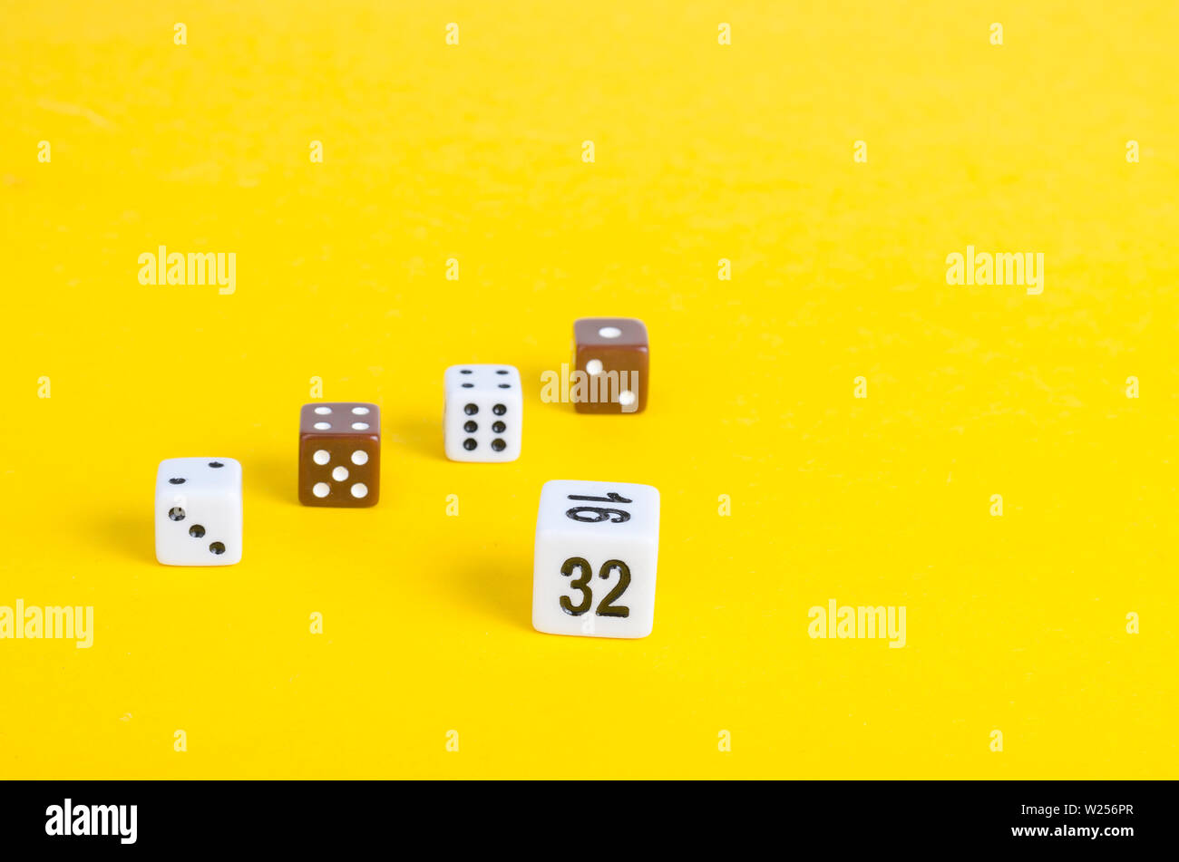 Simple game cubes, dice on bright yellow background. Casino gambling ...