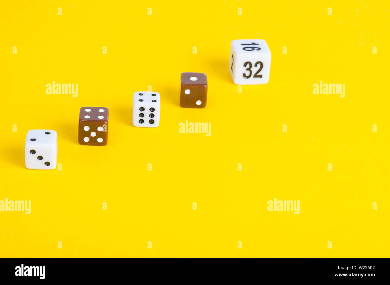 Simple game cubes, dice on bright yellow background. Casino gambling ...
