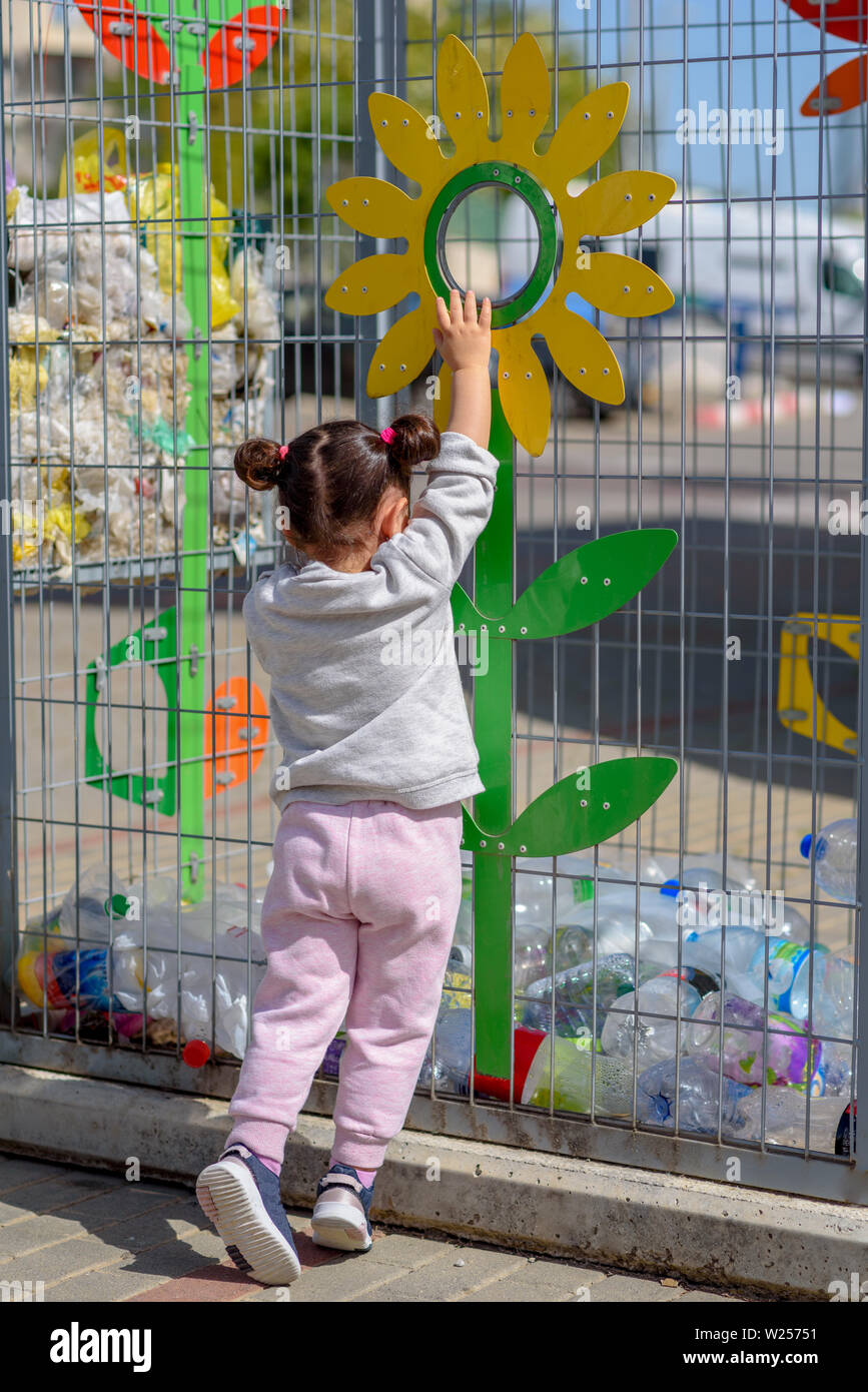 Little Girl Putting Waste Into Recycling Bin. Funny Child Recycling ...
