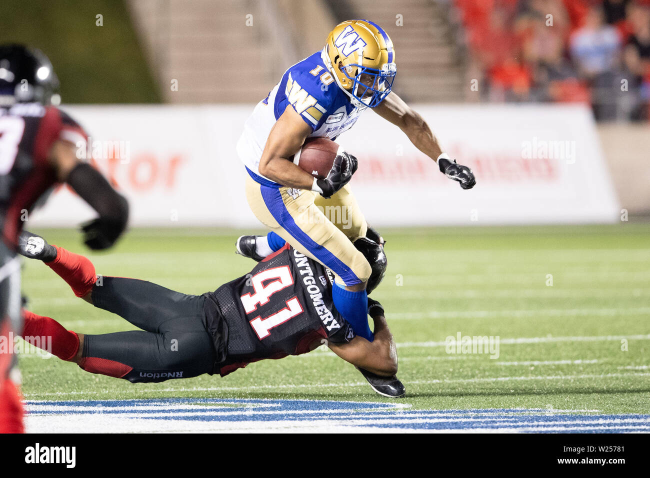 July 05, 2019: Winnipeg Blue Bombers Nic Demski (10) is tackled by Ottawa Redblacks De'Andre ...