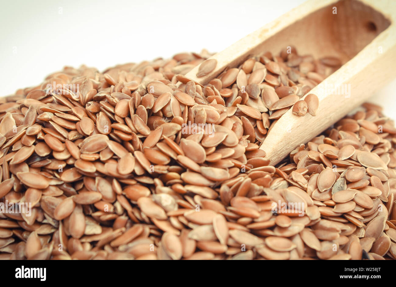Linseed with wooden spoon. White background. Concept of healthy food ...