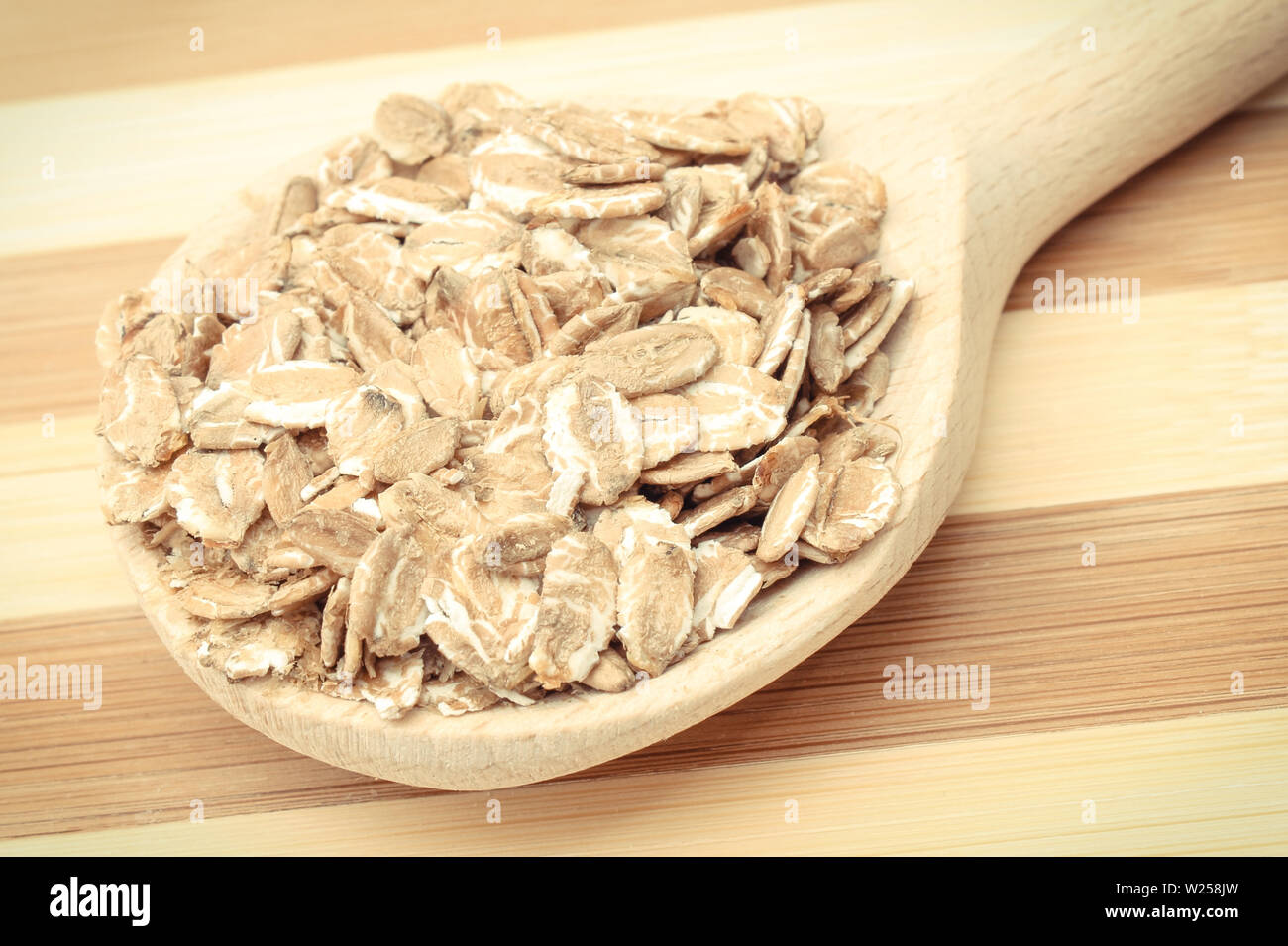 Rye flakes with wooden spoon. Healthy ingredients as source dietary ...