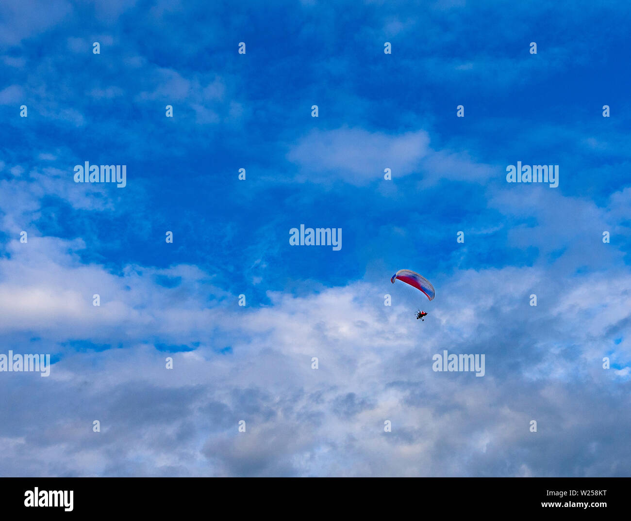 Paragliders with engine with blue sky background Stock Photo - Alamy