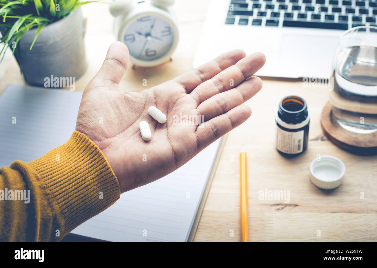 Male eating medicine,pill (vitamin) on work in morning.healthy ...