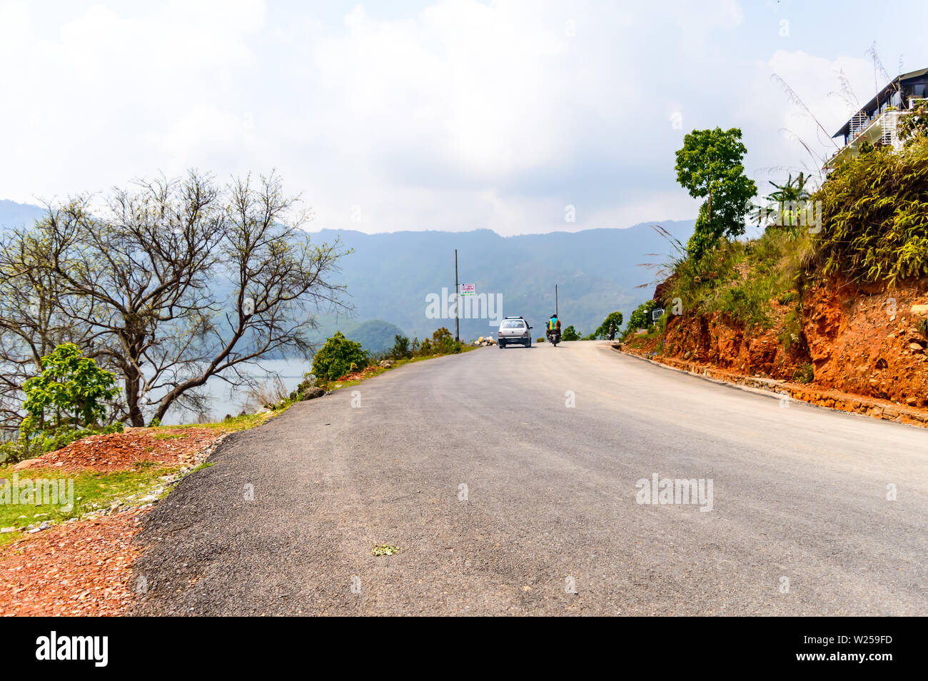 Photograph of empty road with hill in surrounding near Pokhara Lake at ...