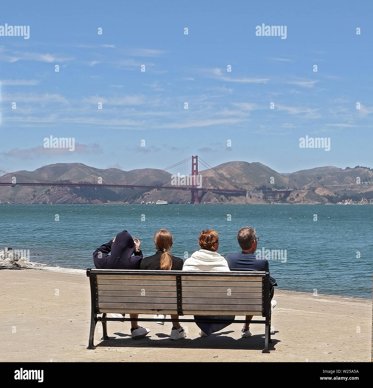 San Francisco, California - June 28, 2019: A family sitting on the ...