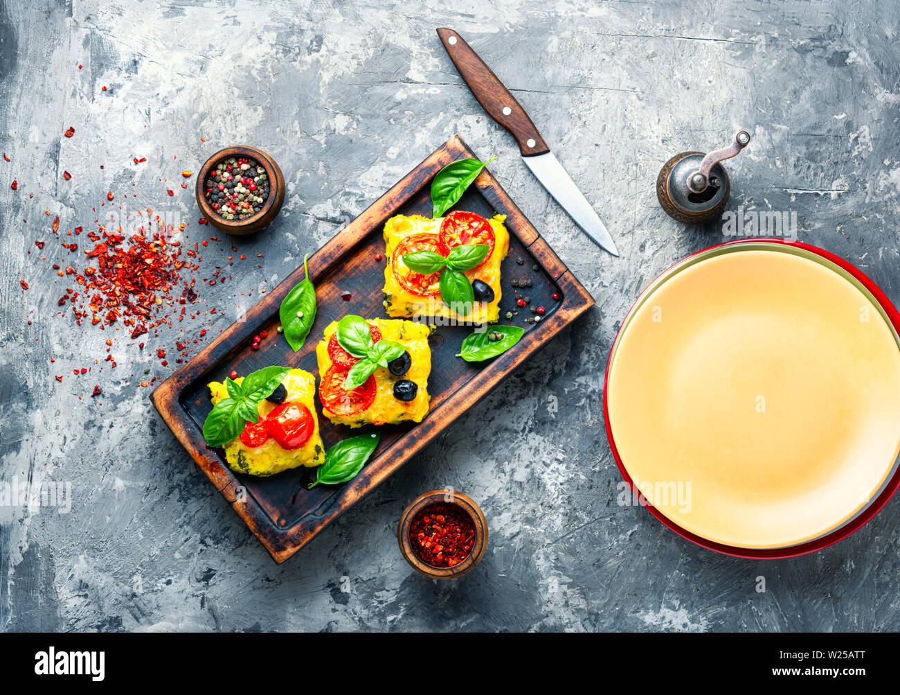 Corn polenta with tomatoes and cheese.Italian cuisine.Pieces corn ...