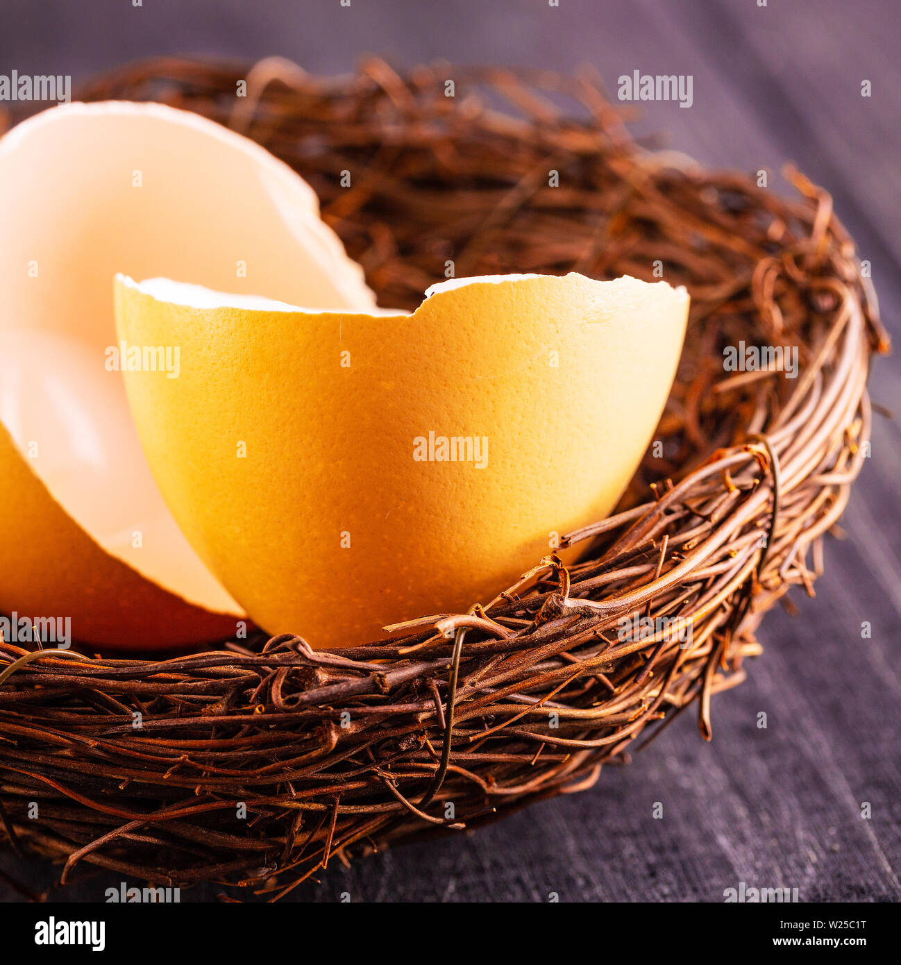 broken egg shells in the nest on the old wooden background. Concept of ...
