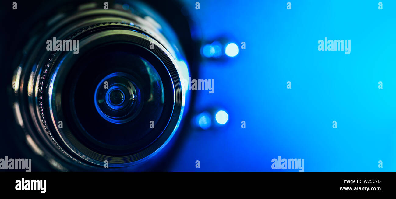 The camera lens and blue backlighting . Horizontal photography. Banner ...