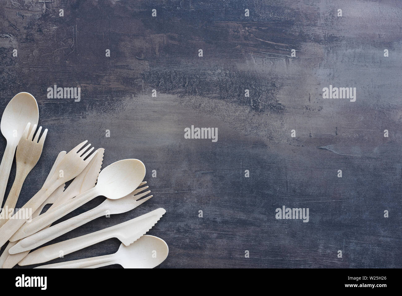 Top view of scattered wooden cutlery - spoons, forks and knifes on ...