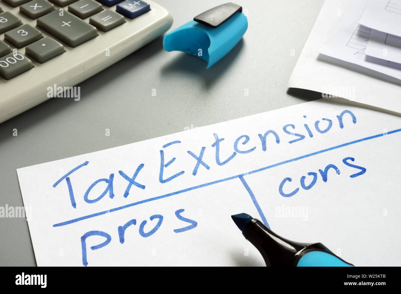 Tax extension pros and cons list on desk Stock Photo - Alamy