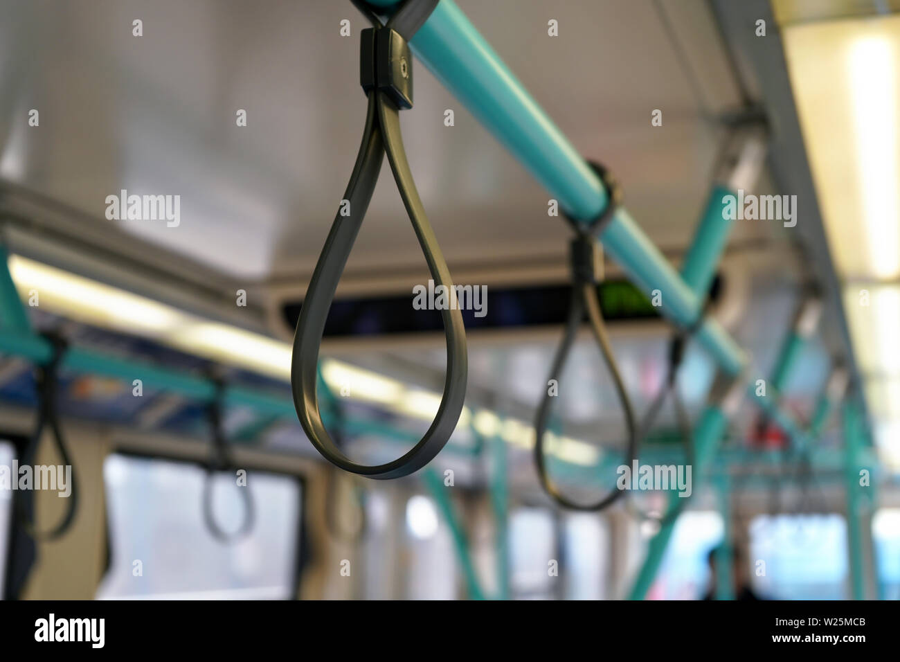 Rubber handle loops on light blue tube, for passengers to hold safely ...