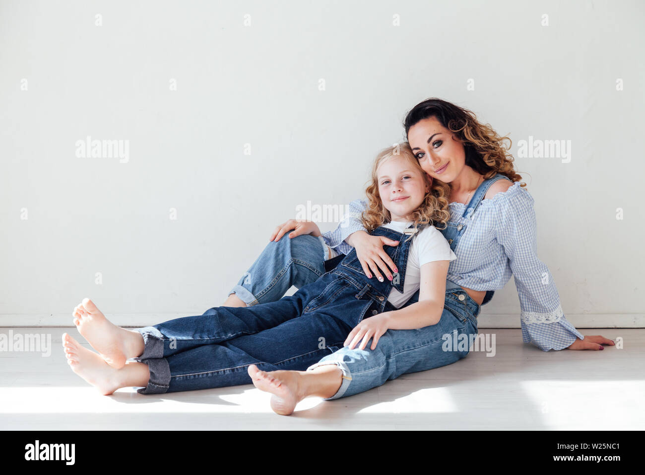 Mom and daughter play cuddles at home on the floor Stock Photo - Alamy