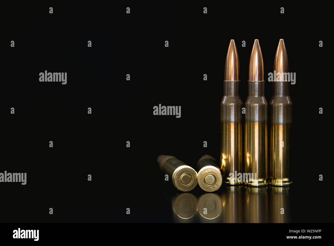 Bullet isolated on black background with reflexion. Rifle bullets close ...