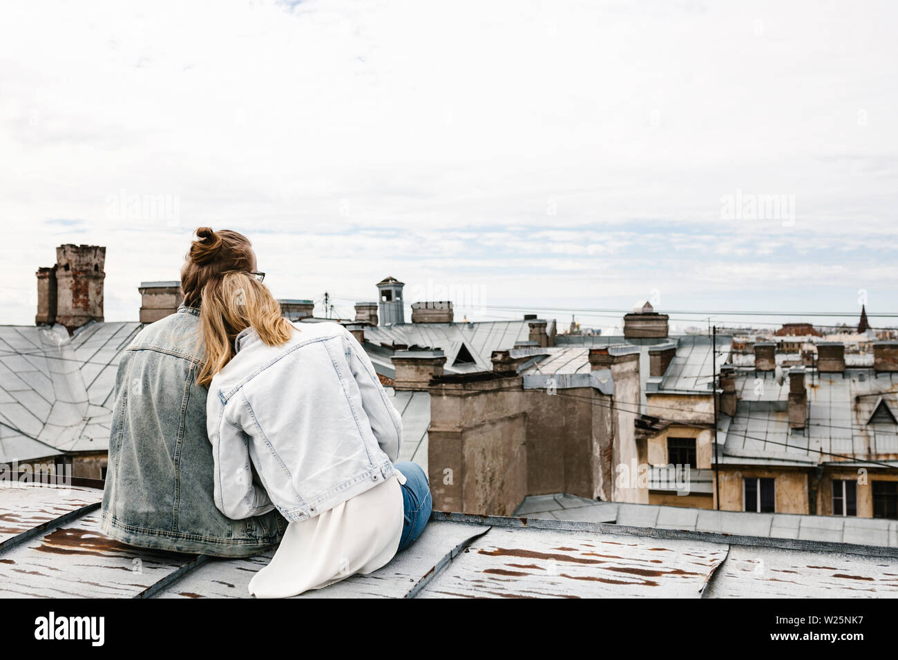 Two people sit on roof hi-res stock photography and images - Alamy