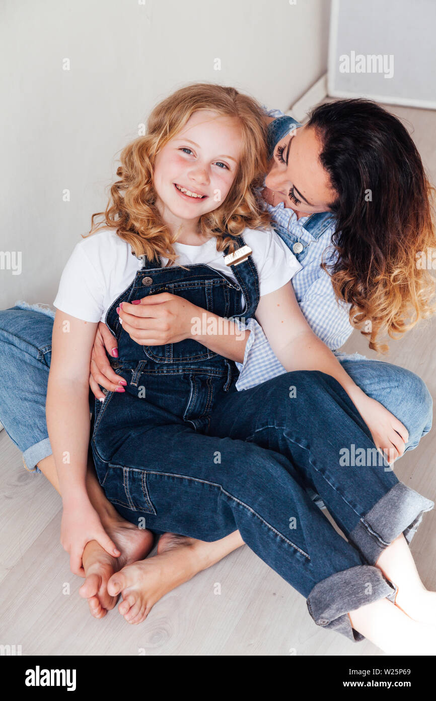 Mom and daughter play cuddles at home on the floor Stock Photo - Alamy