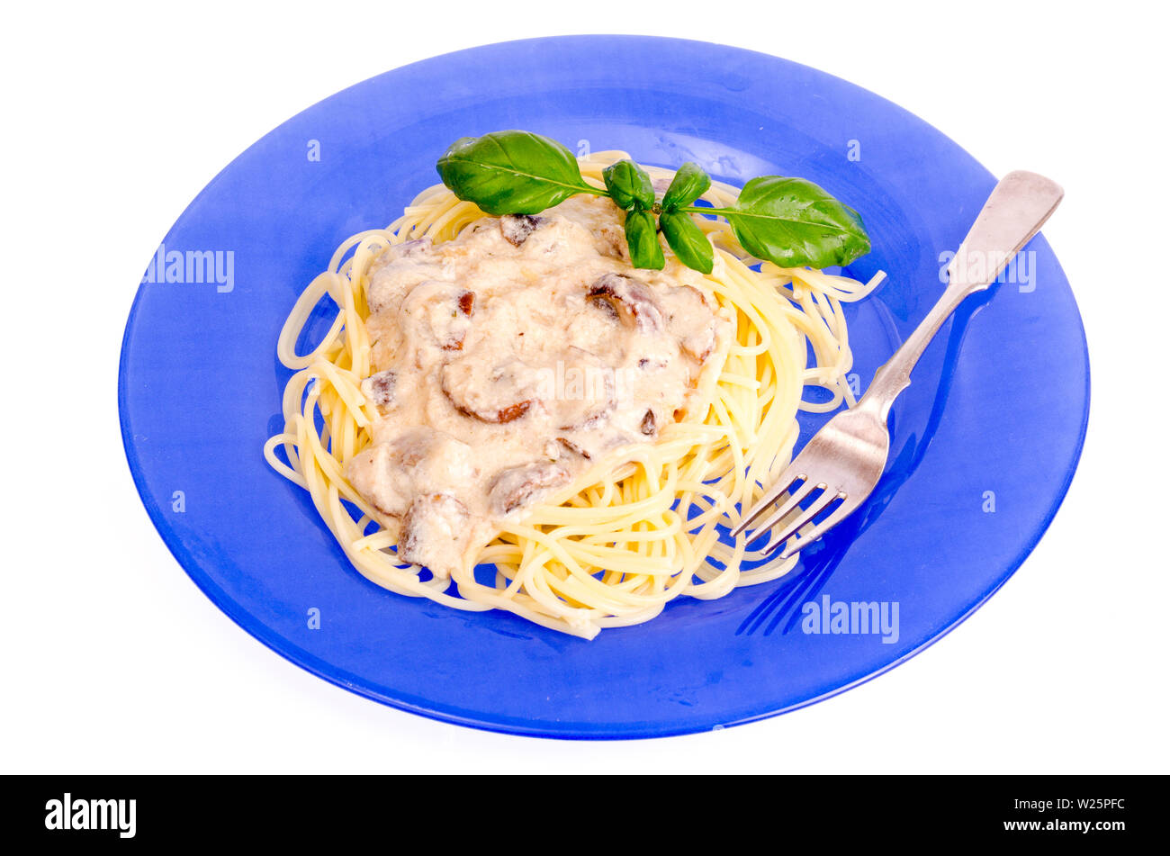 Blue plate with spaghetti and mushroom sauce Stock Photo - Alamy
