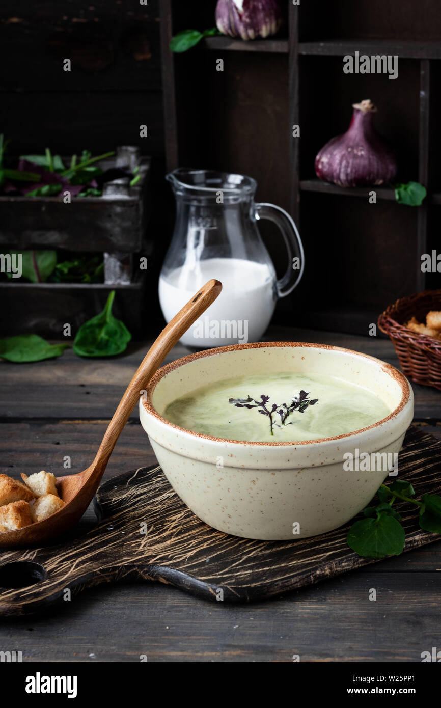 Creamy soup puree with spinach on a dark background Stock Photo - Alamy