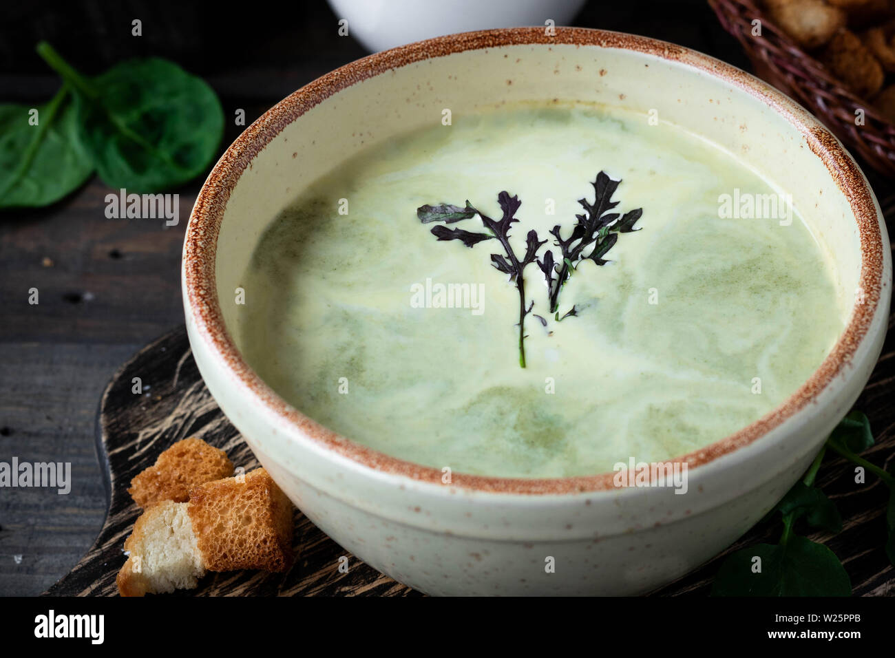 Creamy soup puree with spinach on a dark background Stock Photo - Alamy