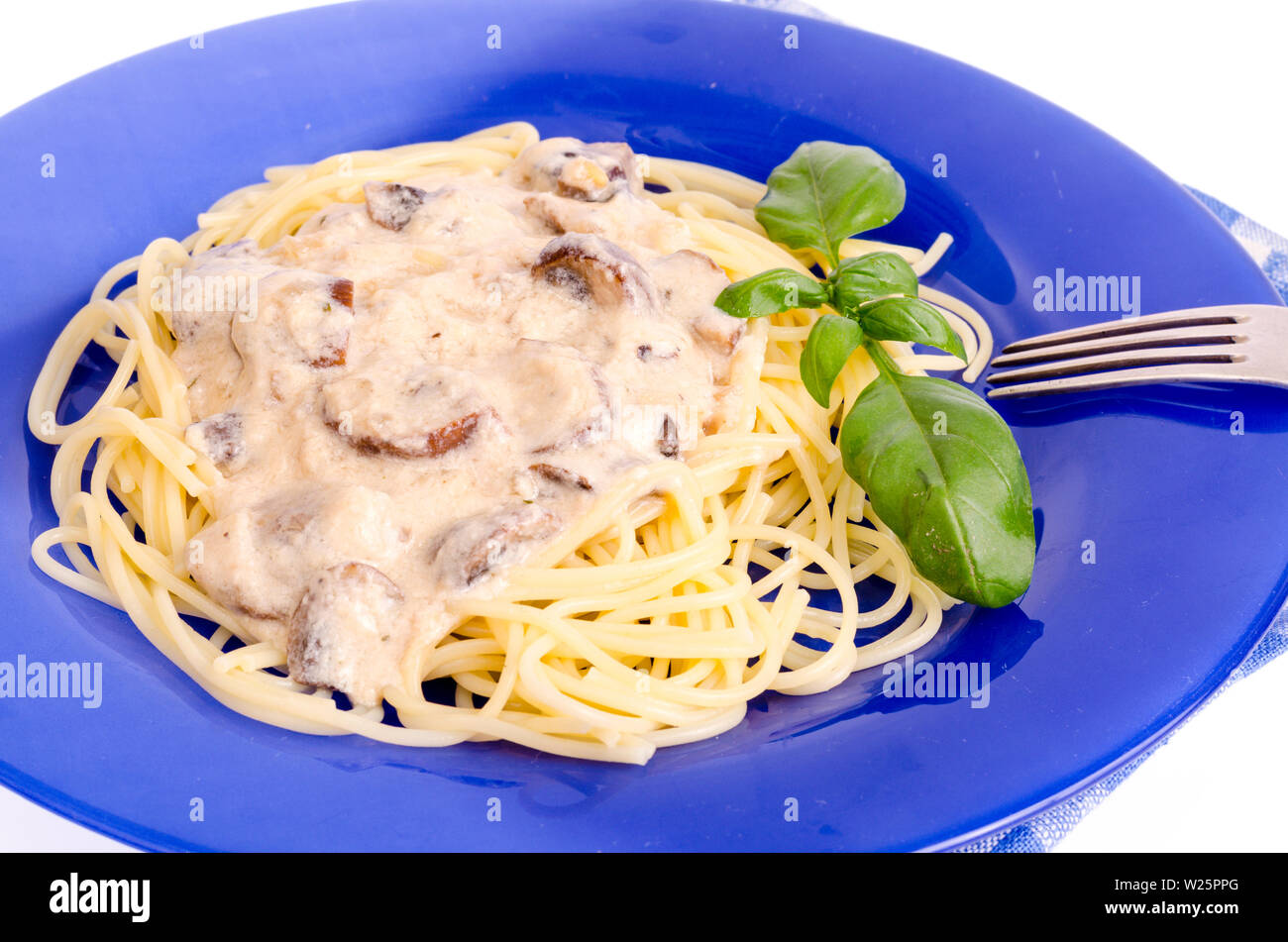 Blue plate with spaghetti and mushroom sauce Stock Photo - Alamy