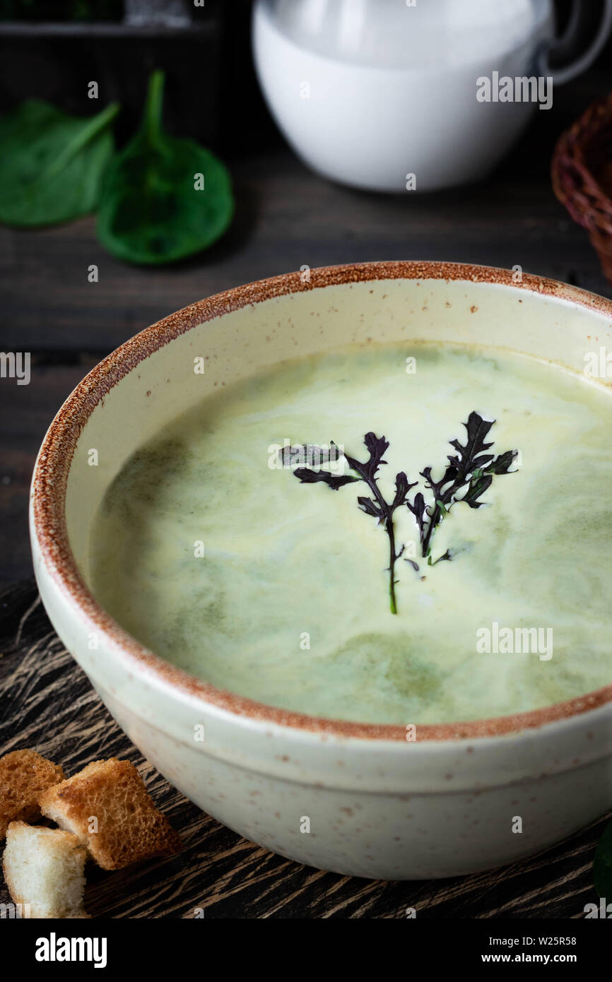 Creamy soup puree with spinach on a dark background Stock Photo - Alamy