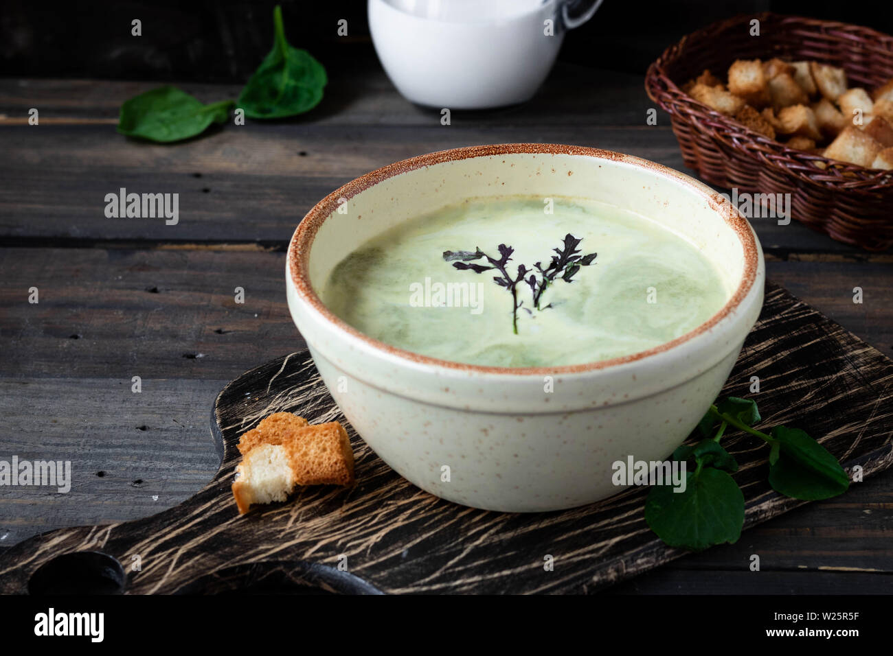 Creamy soup puree with spinach on a dark background Stock Photo - Alamy