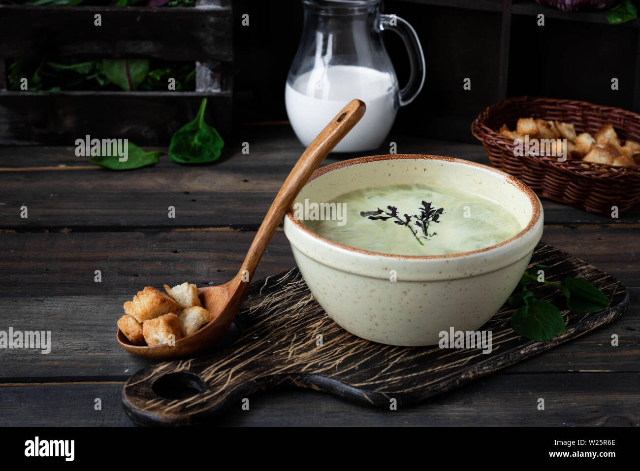 Creamy soup puree with spinach on a dark background Stock Photo - Alamy