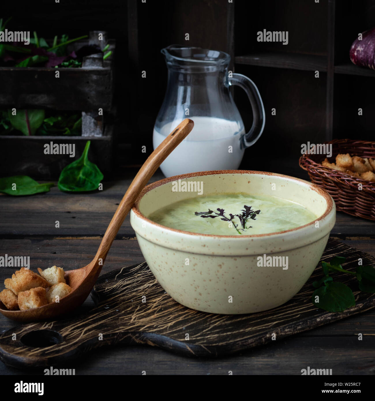 Creamy soup puree with spinach on a dark background Stock Photo - Alamy